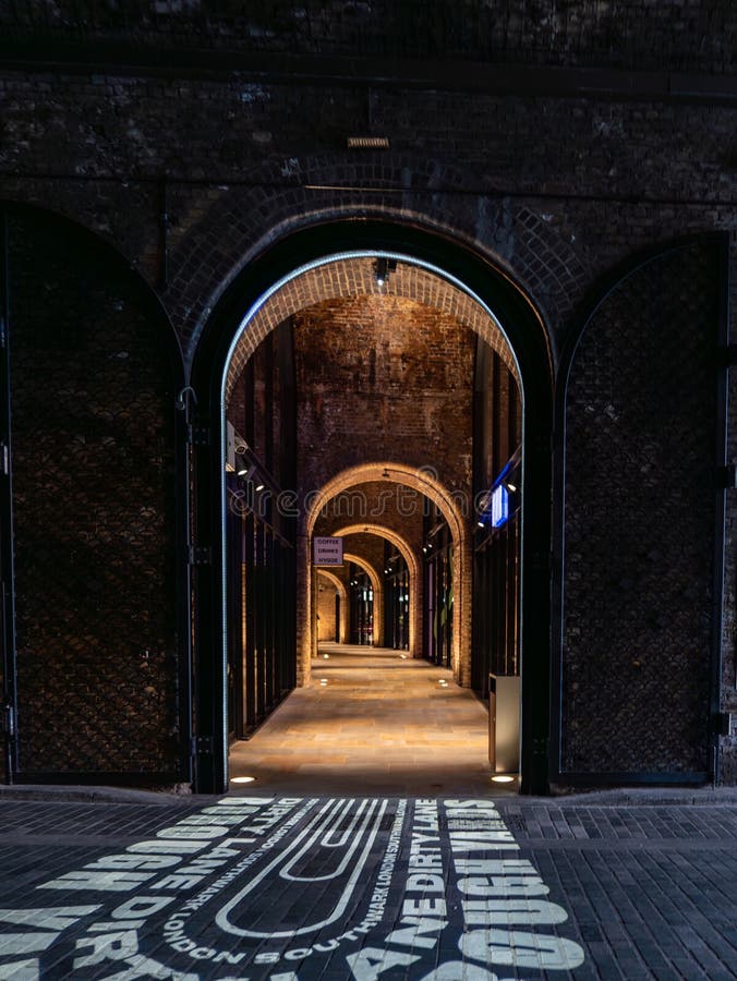 Empty Illuminated Brick Archway Walkway Leading To Shops Stock Image ...