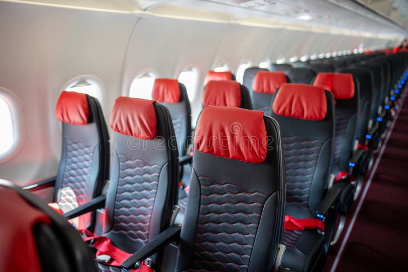Empty Interior of Cabin of Airplane with Rows of Black and Red Seats in ...
