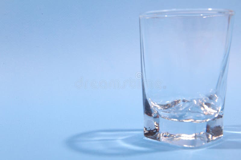 Empty Inverted Glass on Blue Background. Studio Photo Stock Photo ...