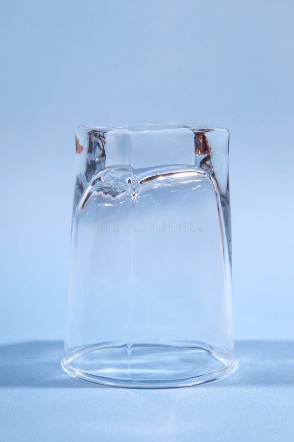Empty Inverted Glass on Blue Background. Studio Photo Stock Photo ...