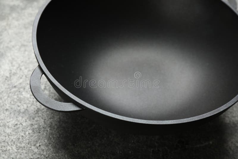Empty Iron Wok on Grey Table, Closeup. Chinese Cookware Stock Photo ...