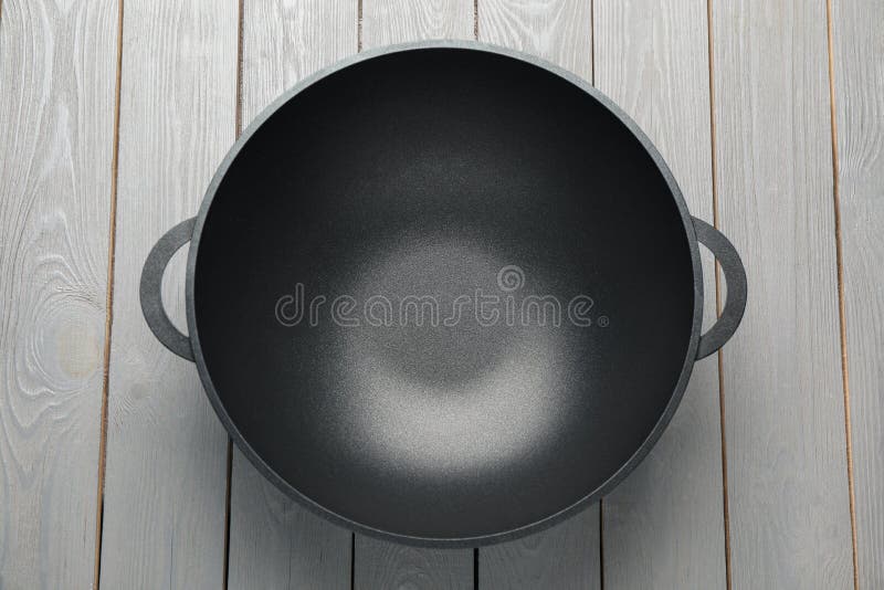 Empty Iron Wok on Grey Wooden Table, Top View. Chinese Cookware Stock ...