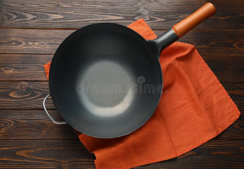 Empty Iron Wok with Napkin on Wooden Table, Top View Stock Image ...