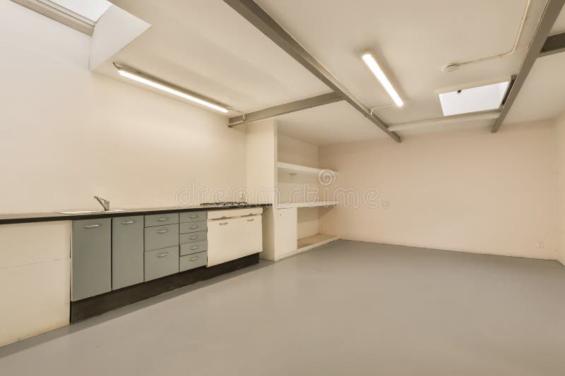 An Empty Kitchen with Counters and Cabinets and a Sink Stock Photo ...