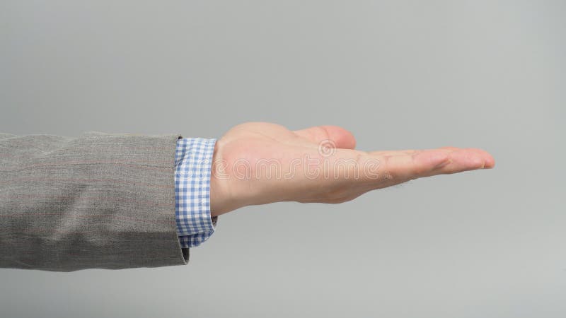 Empty Left Hand Gesture in Grey Suit on Grey Background. Businessman ...
