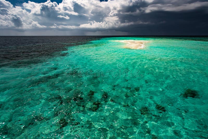 Empty Little Sand Island in Ocean Stock Photo - Image of clouds, small ...