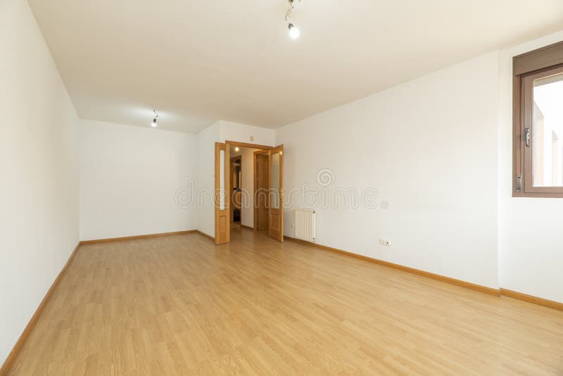 Empty Living Room with Oak Double Doors and Matching Laminated Flooring ...