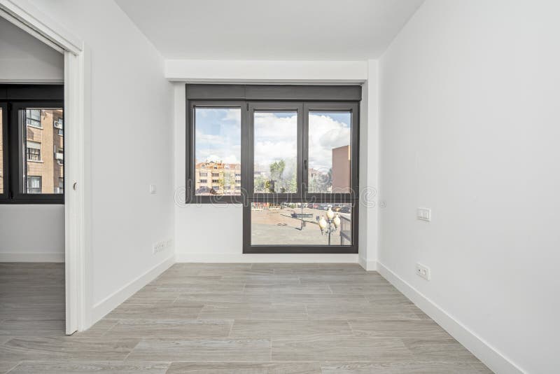 Empty Living Room with Wood-like Stoneware Floors, Large Windows Stock ...