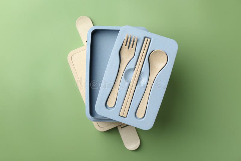 Empty Lunch Box with Cutlery on Green Background, Top View Stock Photo ...