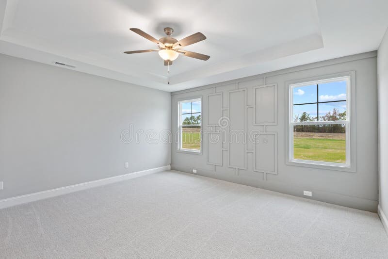 Empty Master Bedroom with Gray Walls, a Ceiling Fan, and Windows ...