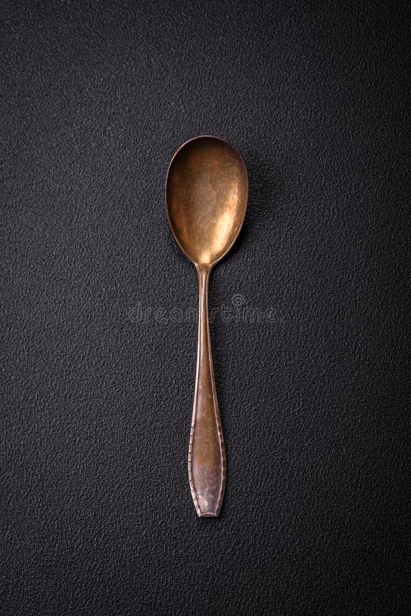 Empty Metal Spoon on Dark Textured Concrete Background Stock Photo ...