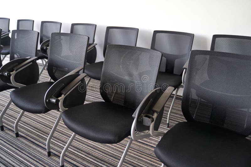 Empty Modern Conference Room with Black Mesh Chairs Arranged in Rows on ...