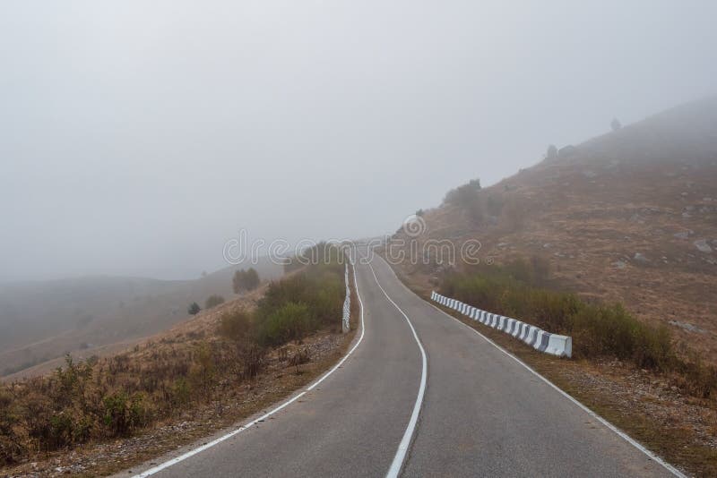 Empty Morning Mountain Highway in a Dense Fog. Road through a Dense Fog ...