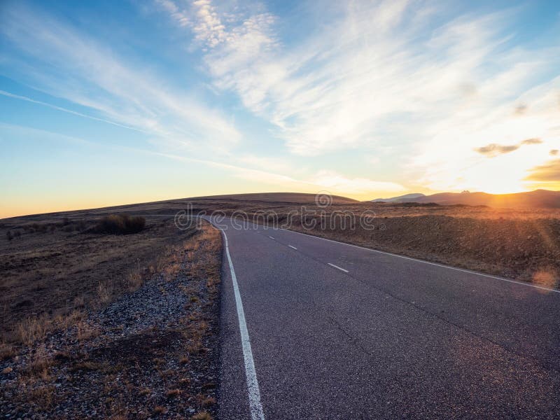 Empty Mountain Highway at Sunset. Asphalt Road and Sky Clouds at Sunset ...