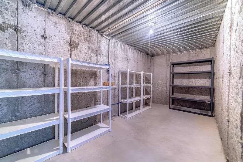 Empty Multi Layer Metal Racks Inside a Storage Room with Concrete Wall ...