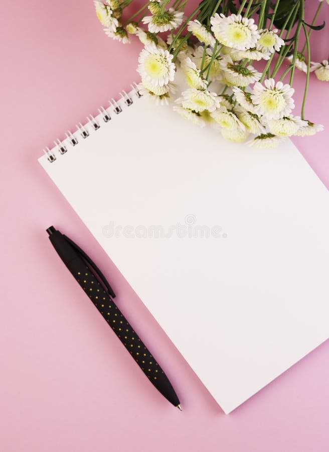 An Empty Notepad with a Pen and a Flower Bouquet on a Pastel Pink ...