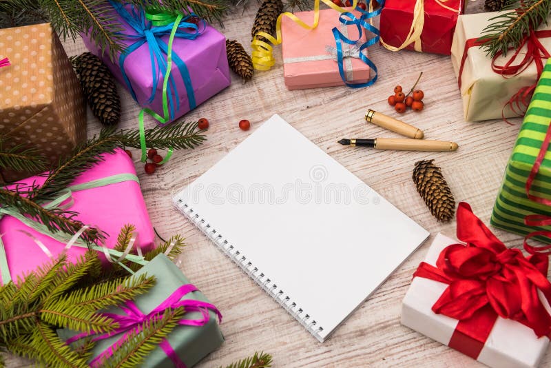 Empty Notepad on Wooden Table with Gift Boxes and Fir Branches ...