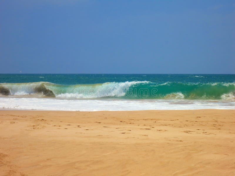 Empty Ocean Beach with Yellow Clear Sand and Blue Waves Stock Photo ...