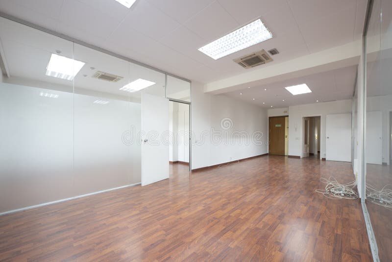 An Empty Office Office with Dark Wooden Floors, Technical Ceilings and ...