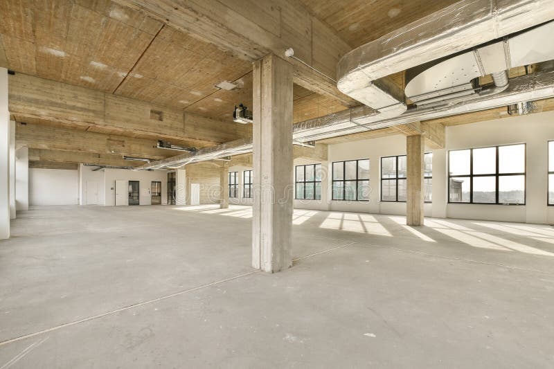 The Interior of a Building with Exposed Ceilings and Windows Stock ...