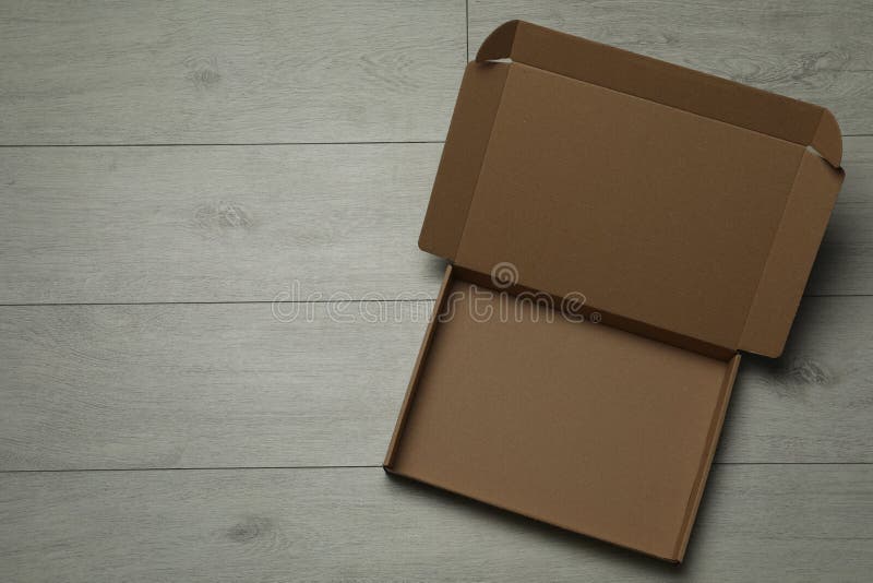 Empty Open Cardboard Box on Floor, Top View. Space for Text Stock Photo ...