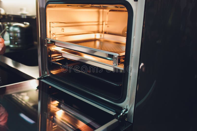 Empty Open Electric Oven with Hot Air Ventilation. New Oven. Door is Open and Light is on. Stock ...