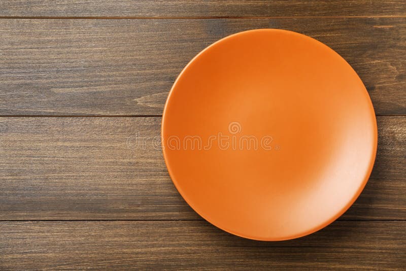 Empty Orange Ceramic Plate on Wooden Table, Top View. Space for Text ...