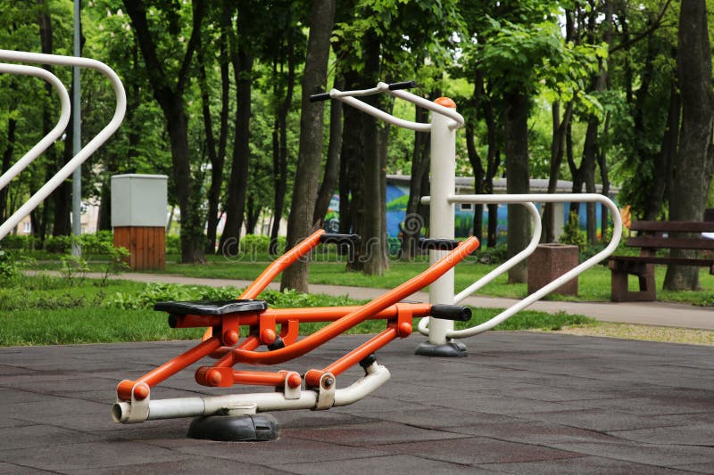 Empty Outdoor Gym with Push Up Bars and Rowing Machine Stock Photo ...
