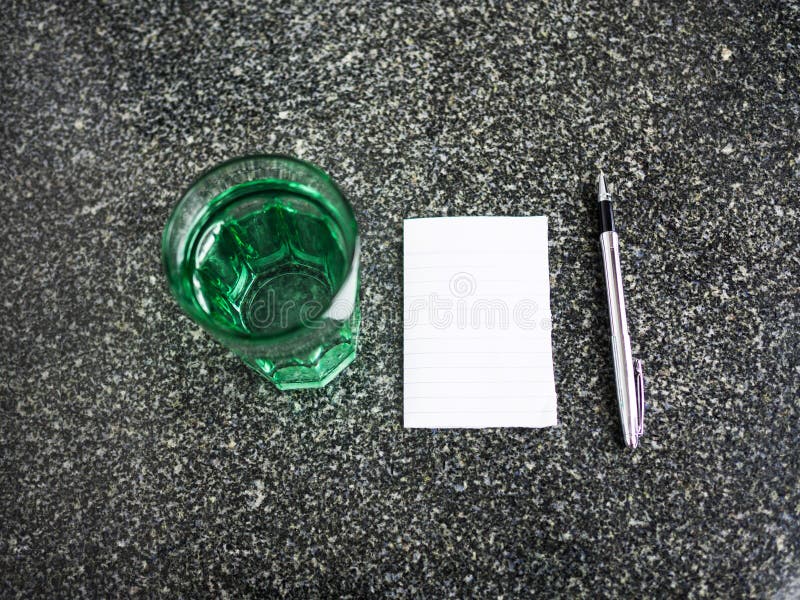 Empty Paper Note with Glass of Water and Pen on Table Stock Photo ...