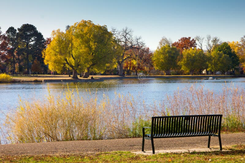 Empty Park Bench by a Lake in Fall - Denver Stock Image - Image of lake ...