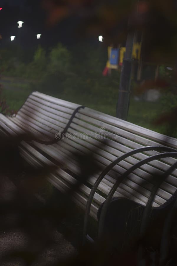 Empty Park Bench at Night with Blurred Background Stock Image - Image ...