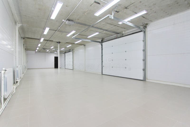 Empty Parking Garage, Warehouse Interior with Large White Gates and ...