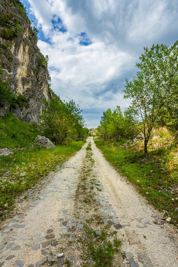 Empty Rural Road through Mountain Clifs Stock Photo - Image of ...
