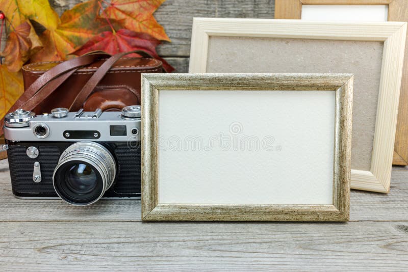 Empty Photo Frames and Classic Camera on Gray Wooden Desk with D Stock ...