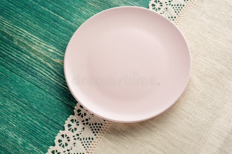 Empty Pink Plate on Tablecloth on Wooden Table. Top View. Stock Image ...