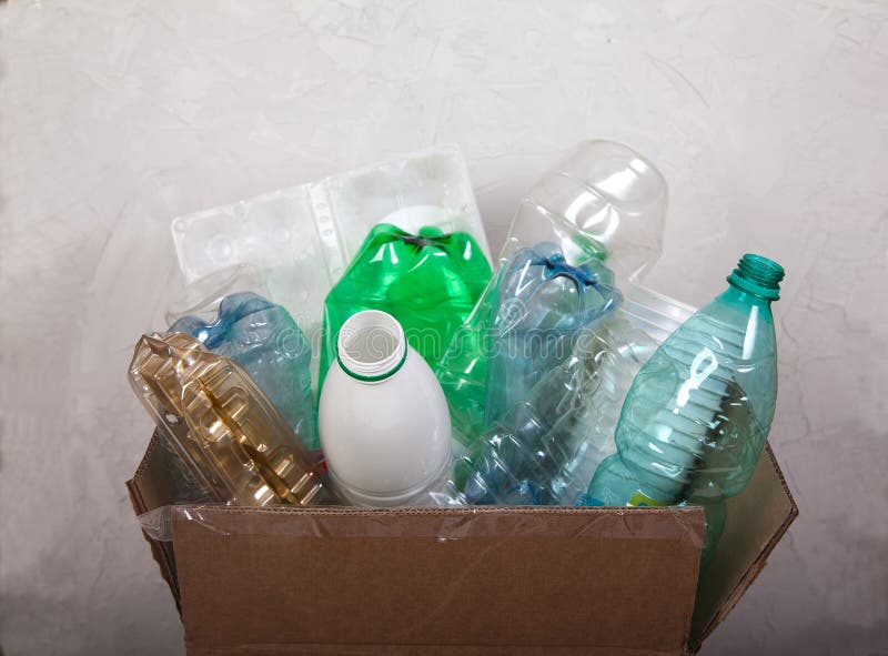 Empty Plastic Bottles Stacked in a Box on a Light Background. Plastic ...