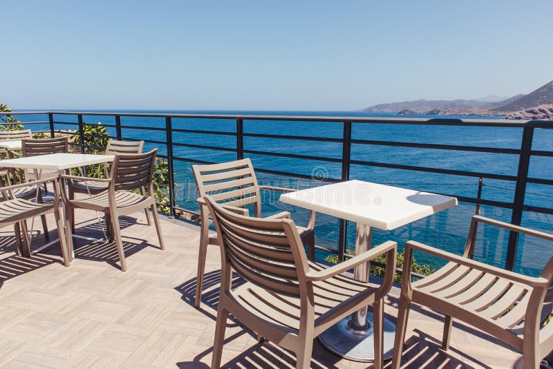 Plastic Chairs and Tables at an Outdoor Cafe on a Balcony with a View ...