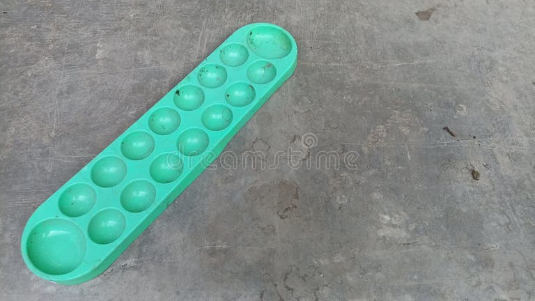 Empty Plastic Dakon Board on Top of a Concrete Tile. Stock Photo ...