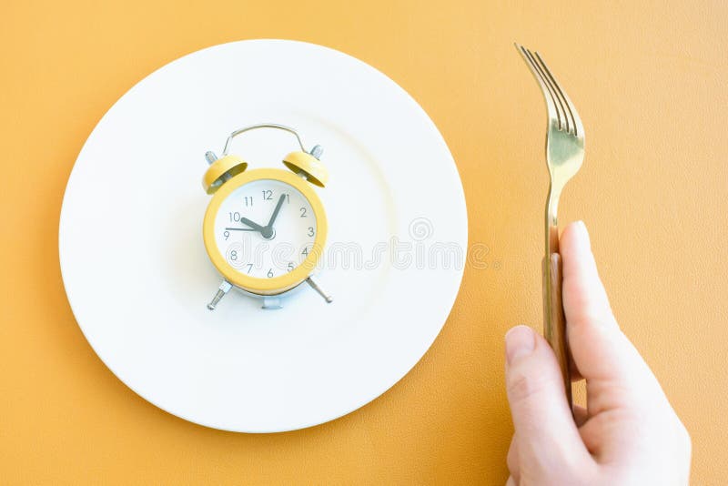 Empty Plate with Alarm Clock and Fork on Brown Background, Intermittent ...