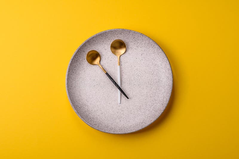 Empty Plate with Devices in the Form of Clock Hands As a Conceptual ...