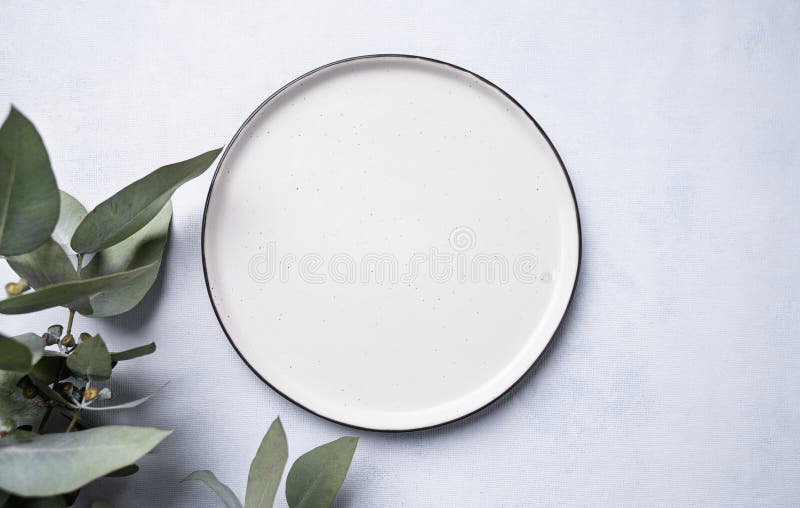 An Empty Plate with Eucalyptus Branches on a Light Background. Festive ...