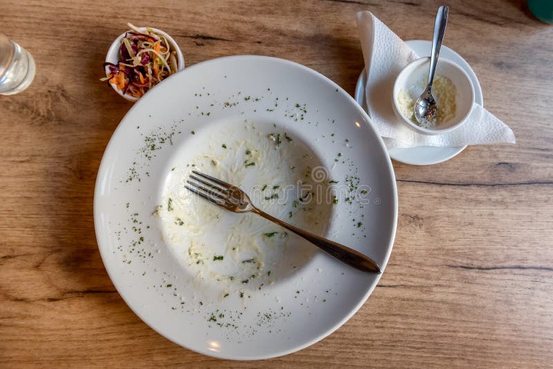 Empty Plate of Food after Meal on a Wooden Table Stock Image - Image of ...