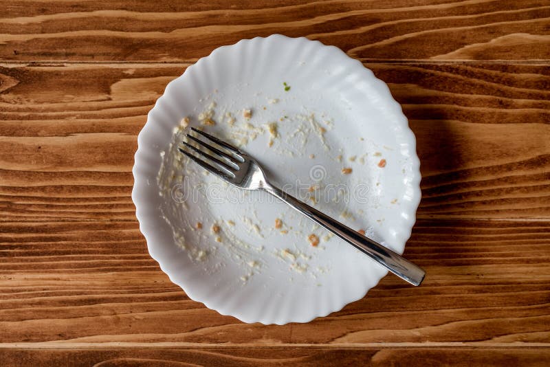 Empty Plate of Food after Meal on a Wooden Table Stock Image - Image of ...