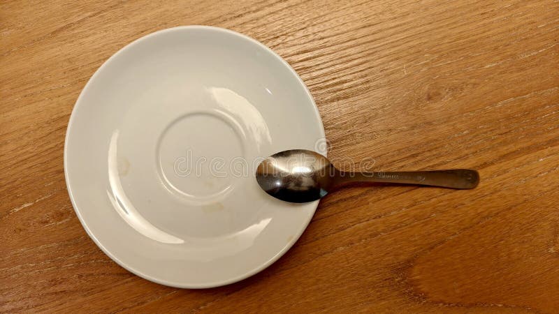 Empty Plate and Teaspoon on the Wooden Table Stock Photo - Image of ...