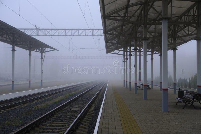 Empty Platform at Station and Rails Going into Fog. Stock Photo - Image ...