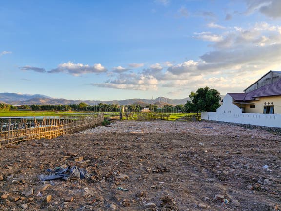 An Empty Plot of Land, Ready for Construction, Surrounded by Lush Green ...