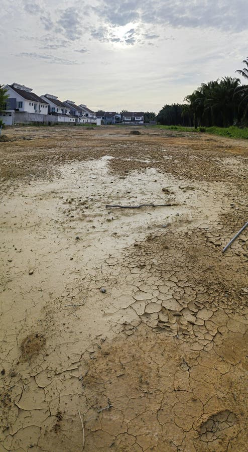 An Empty Plot of Land Scene Besides a Residential Row of Houses. Stock ...