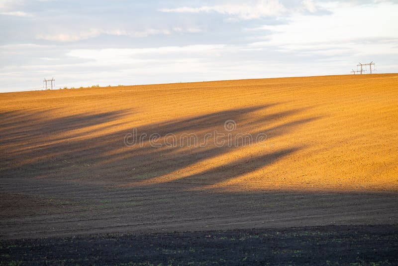 Empty Plowed Field in the Rays of the Evening Sun Stock Image - Image ...