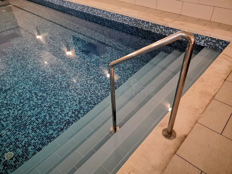 Empty pool inside a hotel stock photo. Image of modern - 161605594