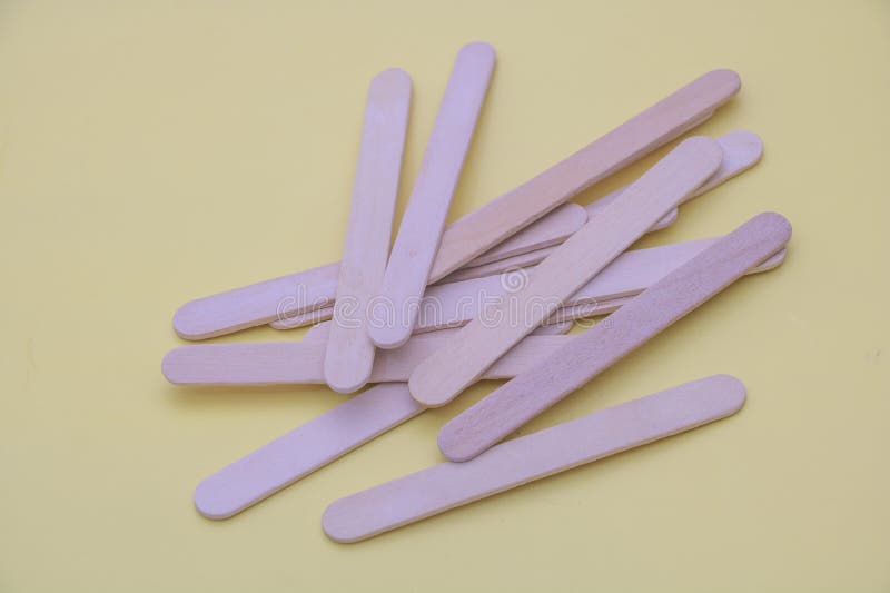Empty Popsicle Sticks, Arranged on a Light Yellow Background. the ...